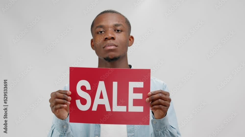 Serious young african american man with text banner sale on white ...