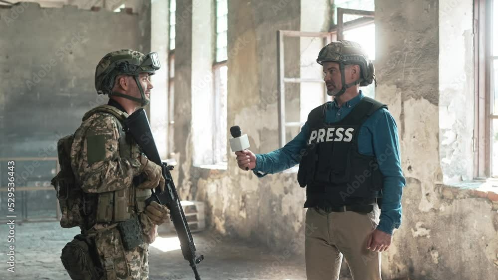 Military man with arms speaking giving interview to a news ...