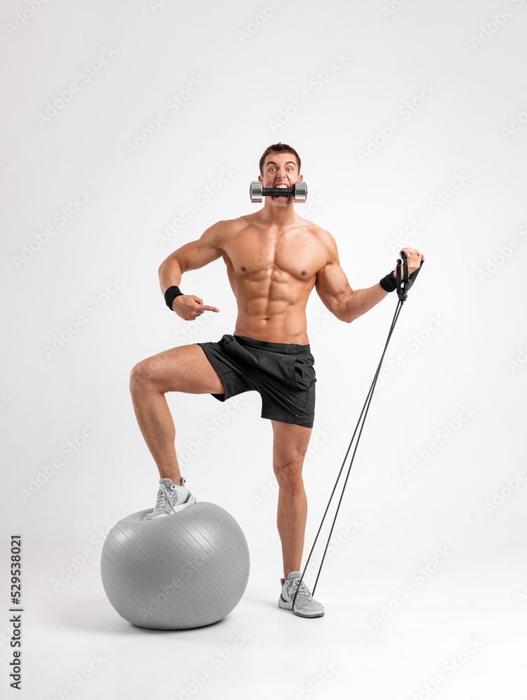 Multitasking athlete shows how to pump up the abdominal muscles. Man ...