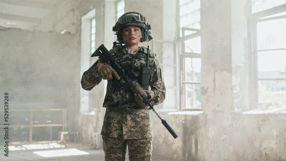Beautiful young adult fully equipped woman soldier holding rifle gun ...