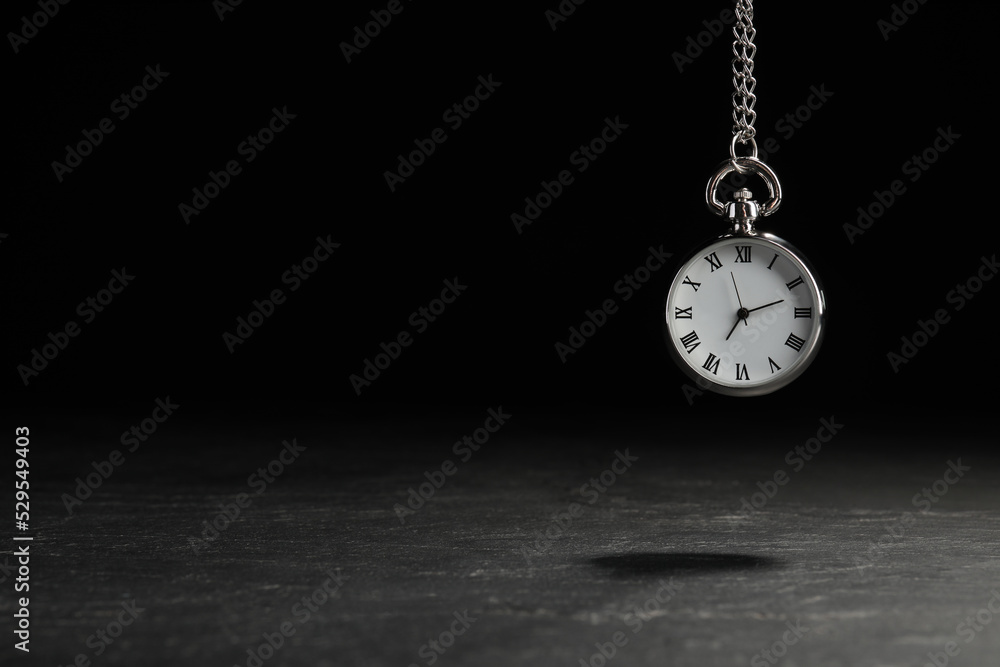 Beautiful vintage pocket watch with silver chain on black background ...