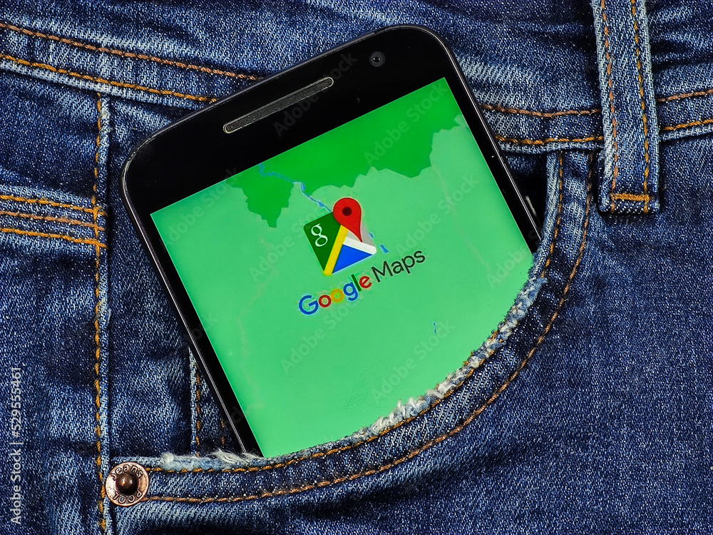 Smartphone with Google Maps logo on the screen in the pocket of jeans ...