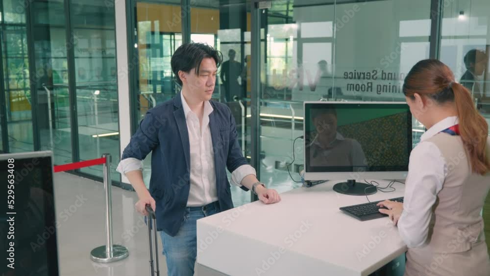 Male tourist in international airport at check-in counter checking ...