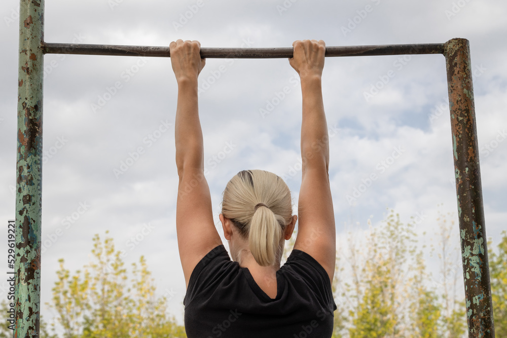 Poster girl hanging on the crossbar on the sports ground – Tableau ...