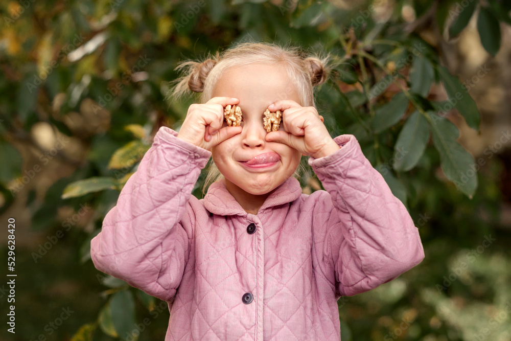 Walnuts in Child in front of Eyes on Nature Background. Peeled walnuts ...