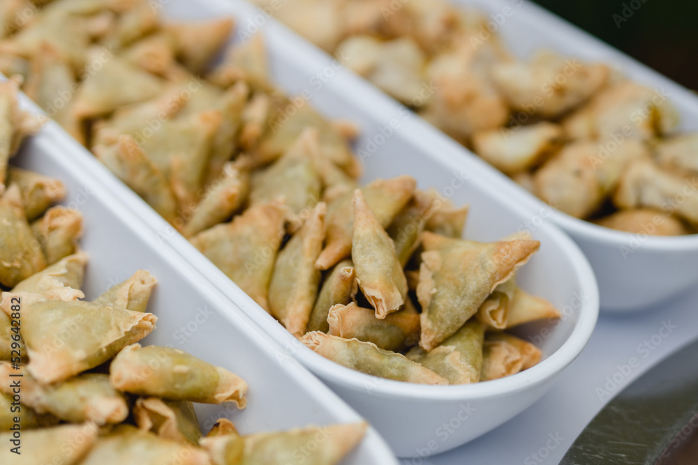 Snack sizes samosas at a buffet Stock Photo | Adobe Stock