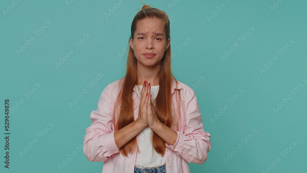 Please, God help. Teenager young girl praying, looking upward and ...