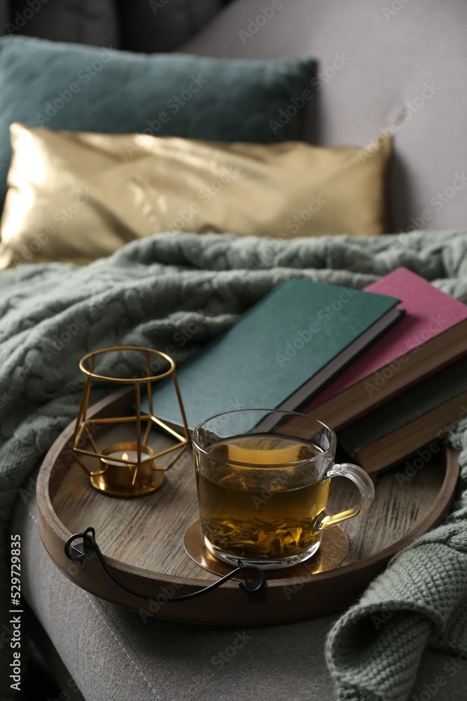 Stylish tray with different interior elements and tea on sofa Stock ...
