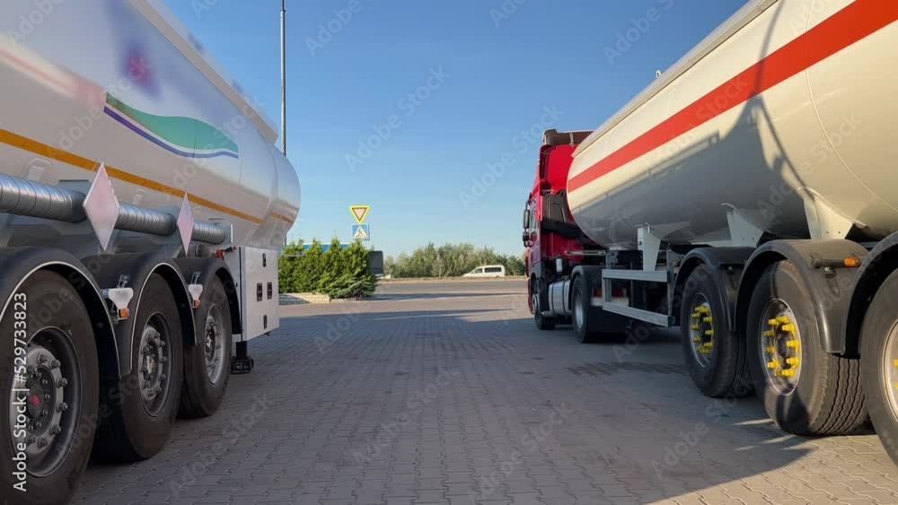 Gasoline trucks stand in the parking lot of the oil depot, waiting for ...