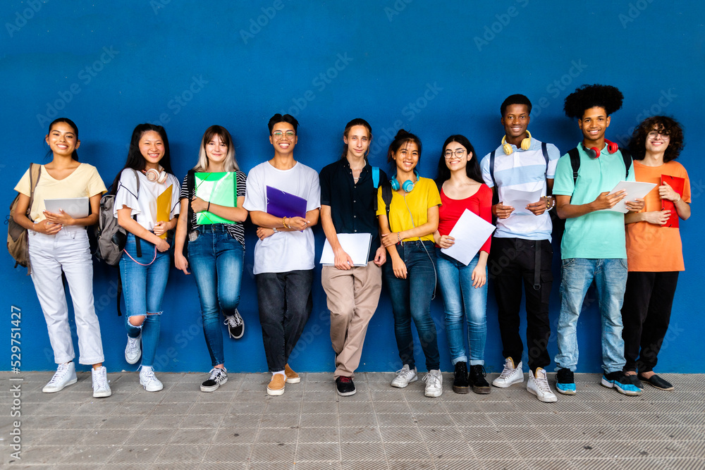 Group of multiracial teenage high school students looking at camera ...