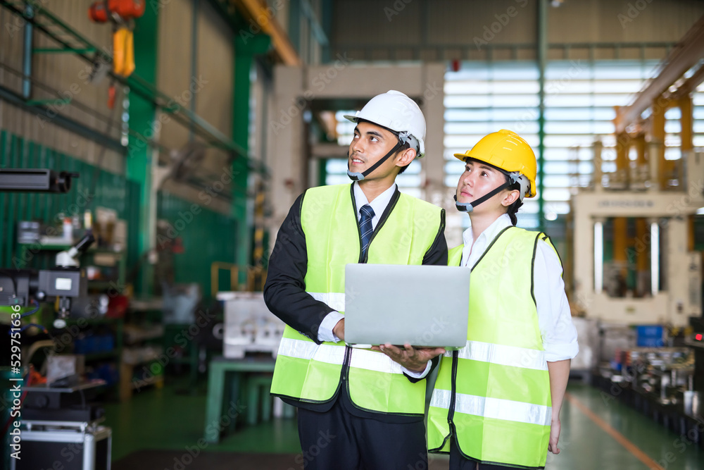 factory workers look at inventory and check stock by company app Stock ...