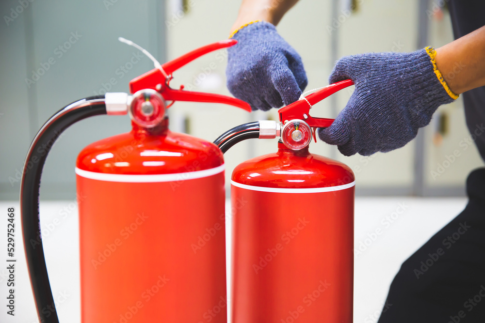 Fire extinguisher has hand engineer pull safety pin on handle to ...