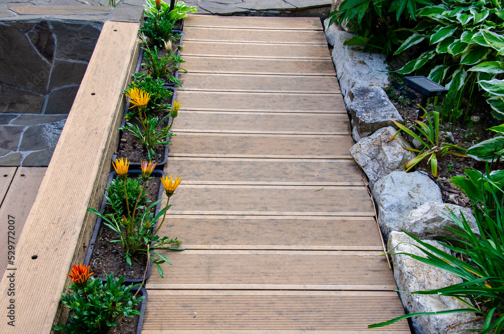 Walkways made of wood-plastic composite boards. A border made of ...