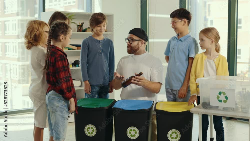 Male teacher teach how and where to sort the rubbish. Garbage sorting ...