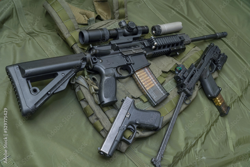 Firearms and tactical equipment. A pistol, a conversion kit with a ...