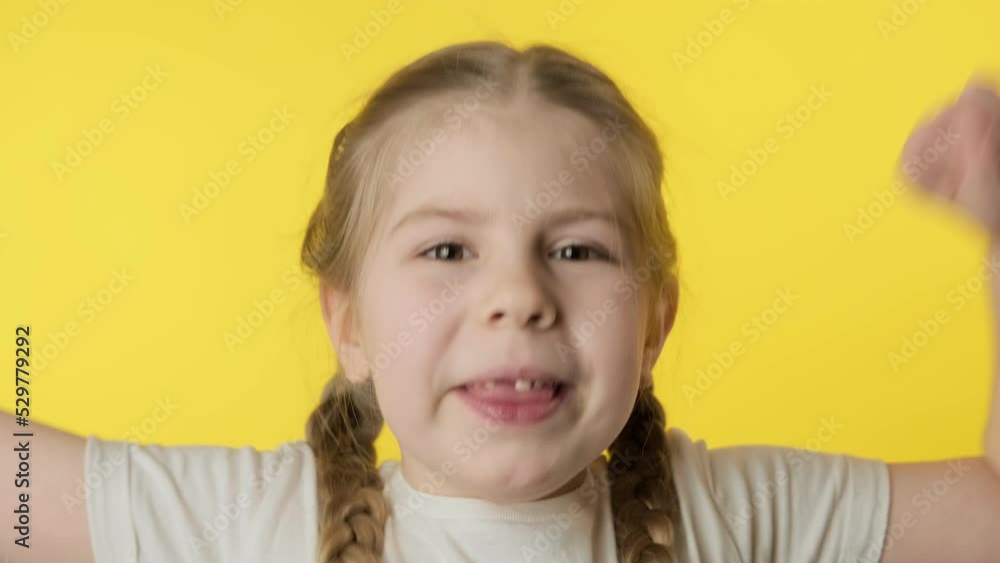 Loss of deciduous tooth. Happy girl with toothless smile looking at ...