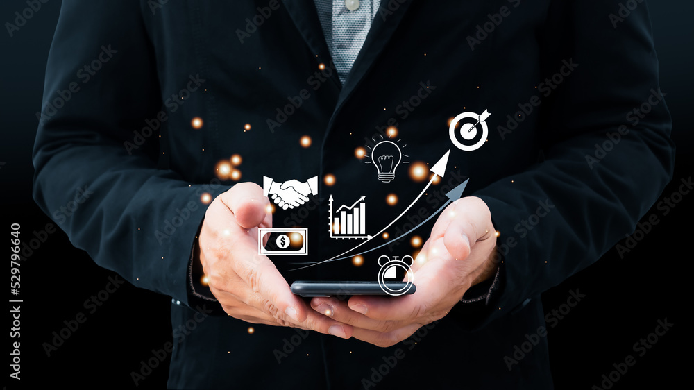 Businessman holding a smartphone with icon business and network ...