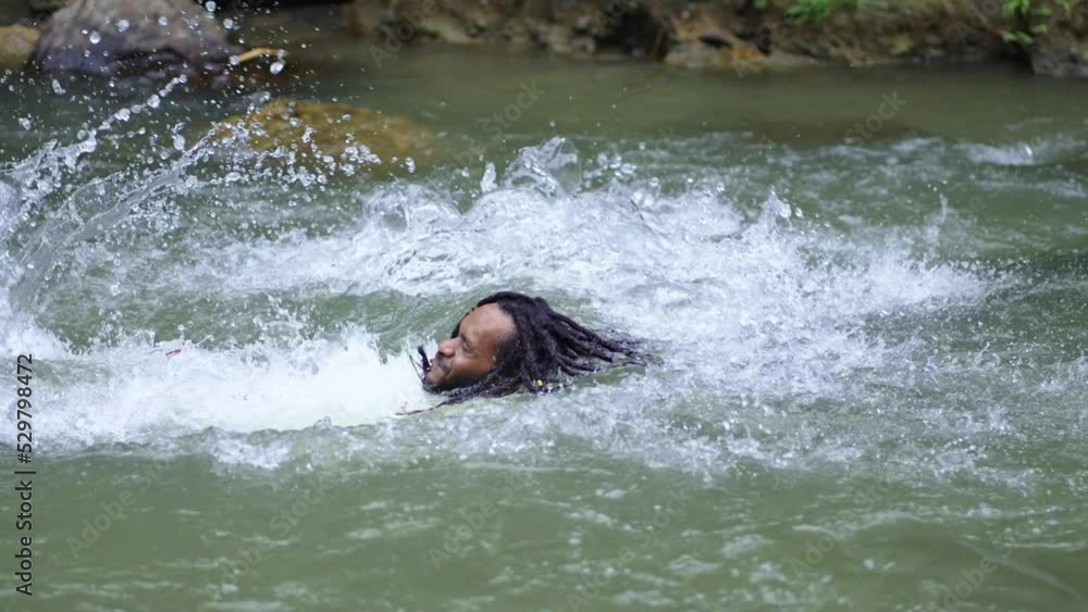Young Black Man With Dreadlocks Dropping Off His Body to Water in a ...