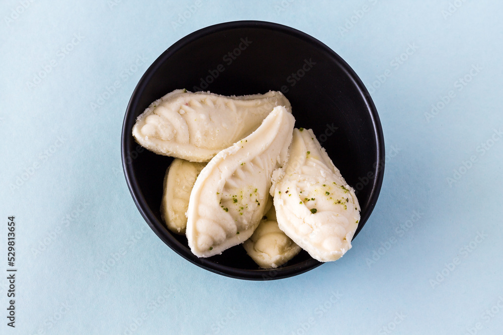 Bowl containing Shankh Sandesh or Shondesh ,a Bengali Sweet or Indian ...