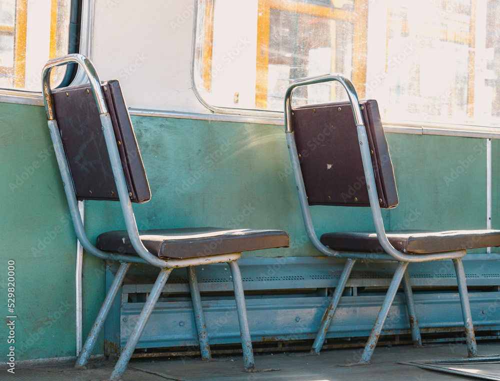 Free seats on the bus. Old brown leather bus seat. Retro bus passenger ...