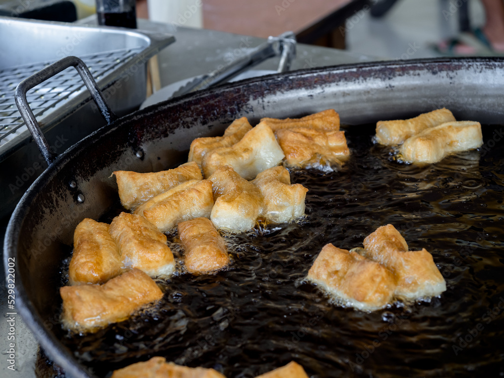 Deep-fried dough sticks or Patongko in Thai, Asian famous street food ...