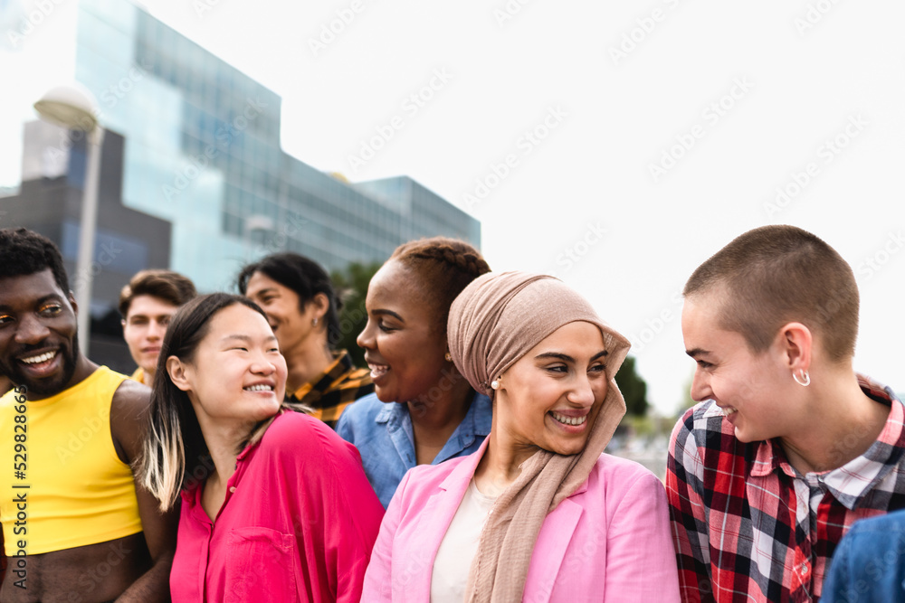 Young multiracial friends having fun together hanging out in the city ...