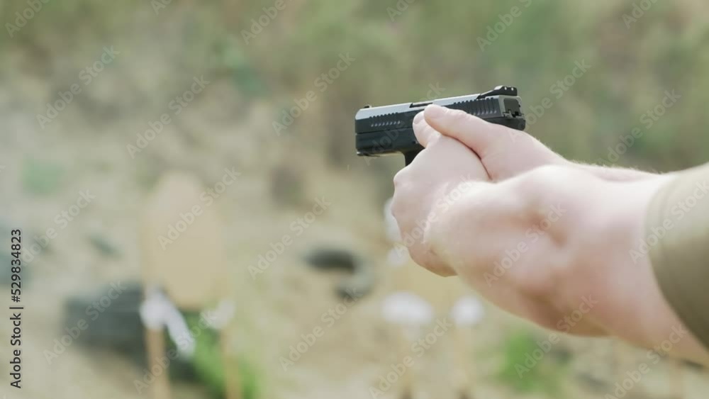A man fires a 9mm pistol. slow shot pistol Stock Video | Adobe Stock