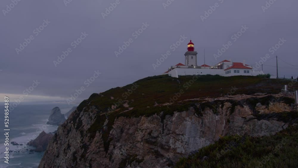 Beautiful dark evening panorama with farol lighthouse in the Atlantic Ocean at Cape Cabo Da Roca ...
