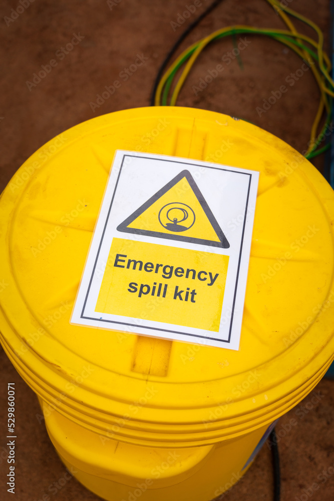 "Emergency spill kit" yellow plastic containment box. Safety sign and ...