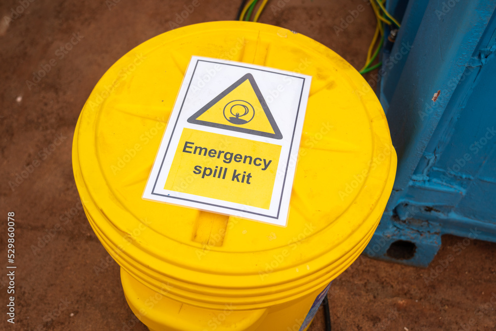 "Emergency spill kit" yellow plastic containment box. Safety sign and ...