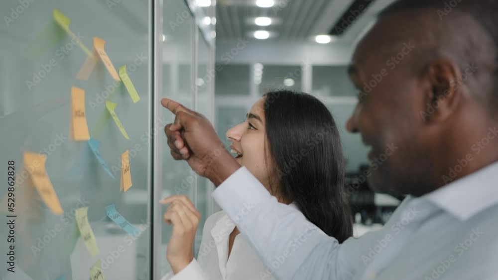Corporate team business partners colleagues look at paper memo stickers ...