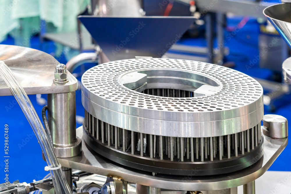 Close up metal stainless steel capsule disc and pin disc on rotary ...