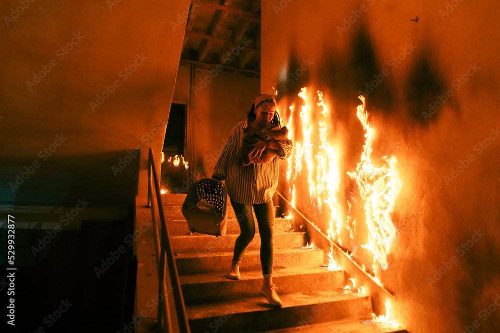 Brave Fireman Descends Stairs of a Burning Building and Holds Saved ...