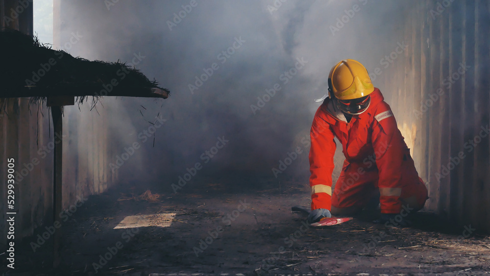 Firefighter fighting with fire flame protection property. Fireman wear ...