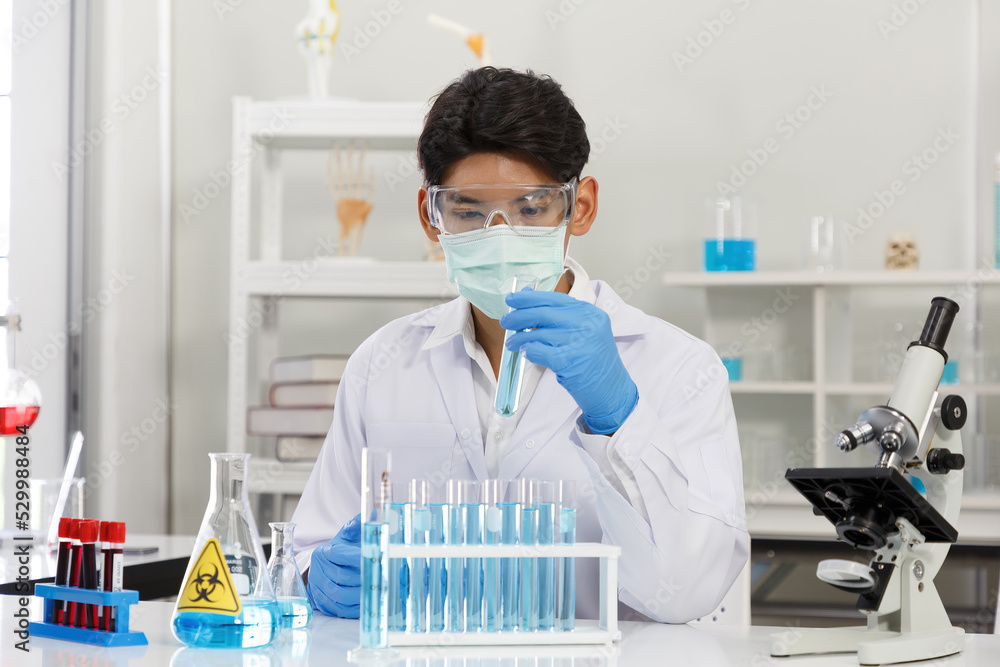 Male Scientist in PPE Suit working in Lab while Pouring Solution from ...