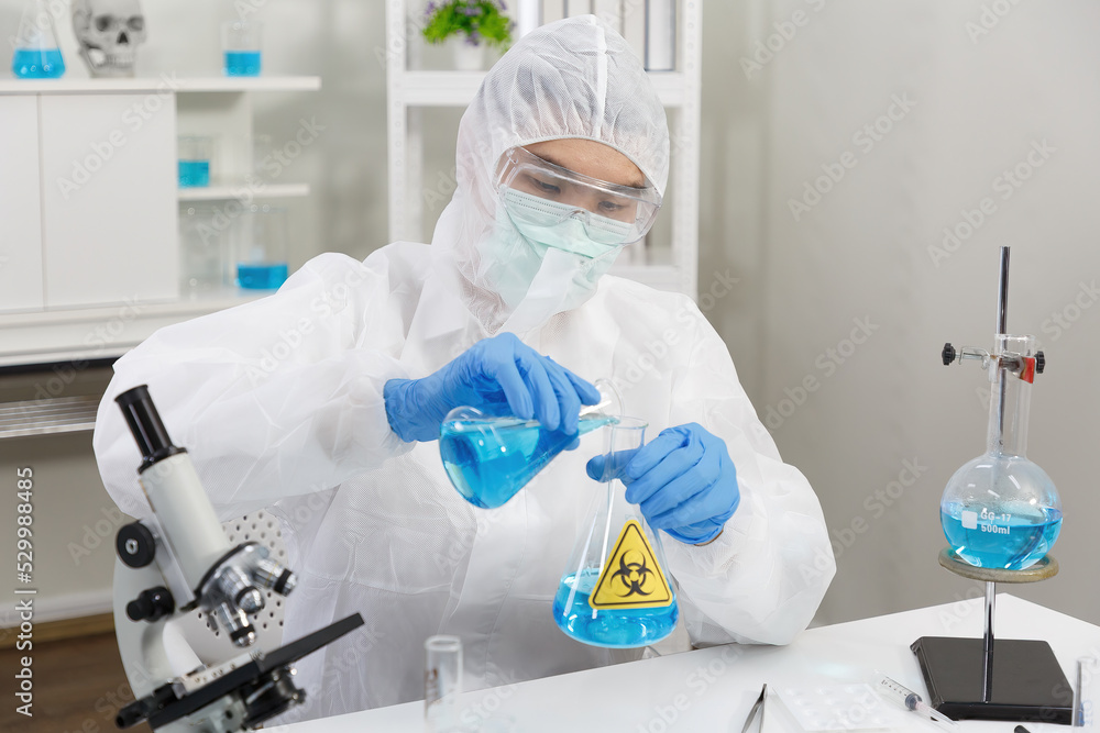 Male Scientist in PPE Suit working in Lab while Pouring Solution from ...