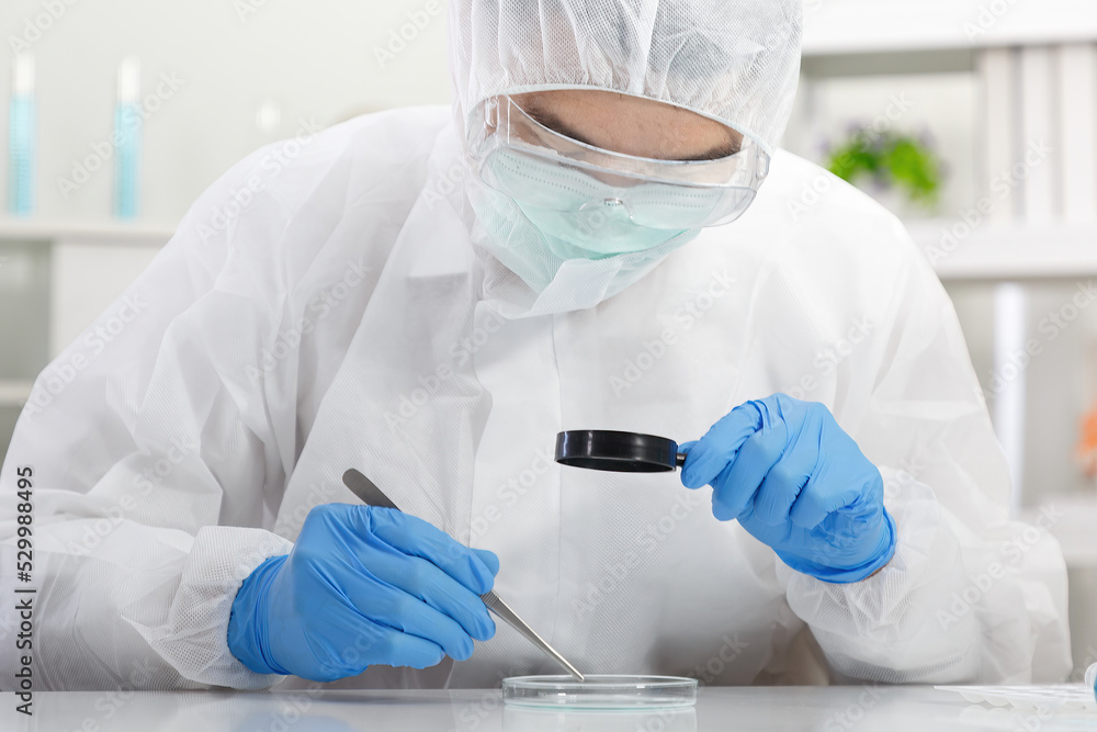 Male Scientist in PPE Suit working in Lab while Pouring Solution from ...