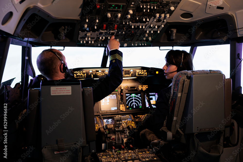 Captain and copilot using dashboard command to takeoff with plane ...