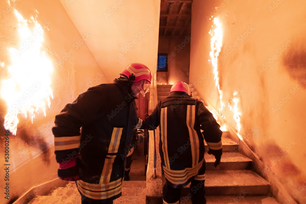 Brave Fireman going upstairs to save and rescue people in a Burning ...