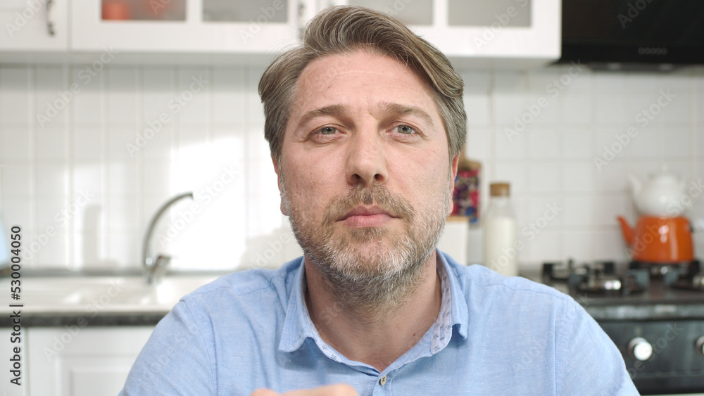 Smiling 40s white-haired man in the kitchen. Friendly looking male ...
