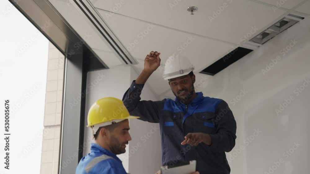 Engineers team installing fire sprinkler in office at building site ...