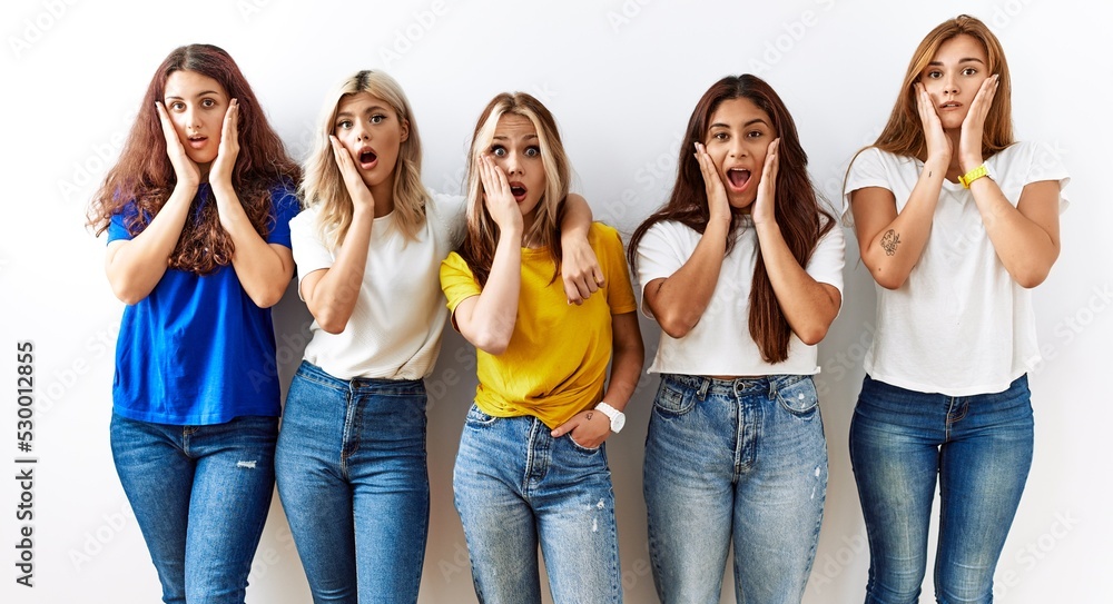 Group of young girl friends standing together over isolated background ...