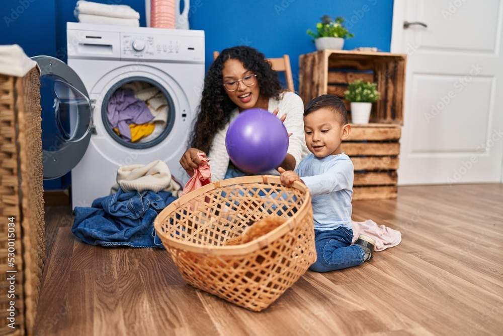 Mother and son smiling confident washing clothes at laundry room Stock ...