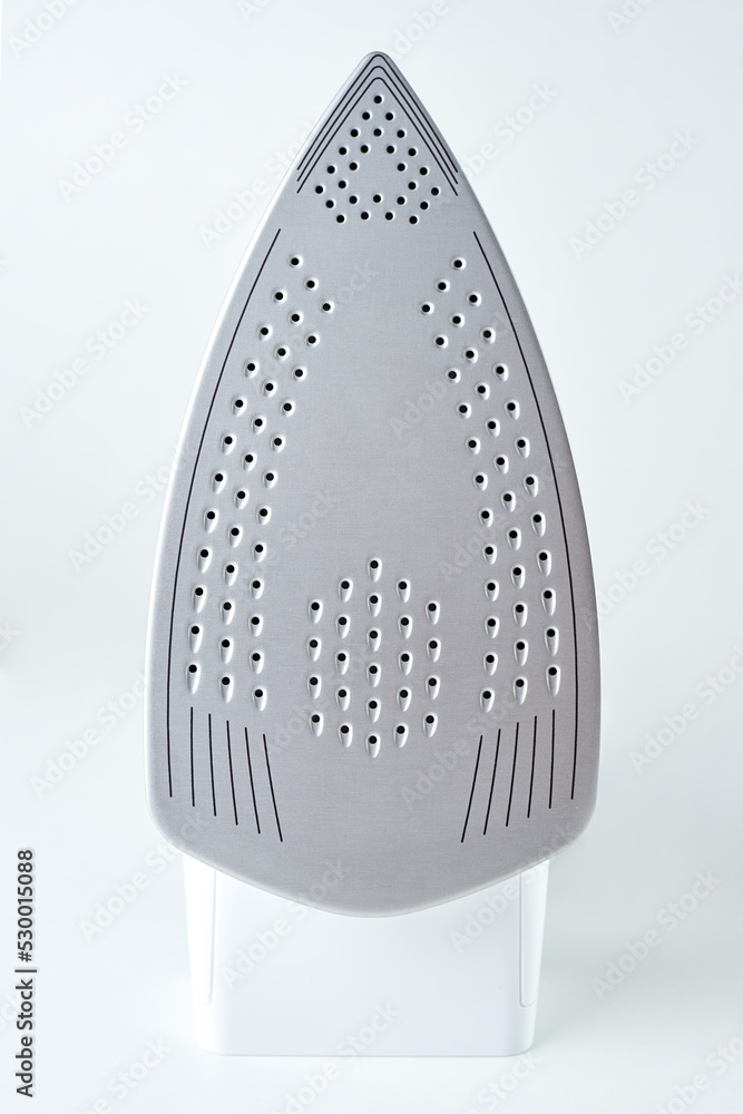 Soleplate of new iron on white background, Modern household appliances ...
