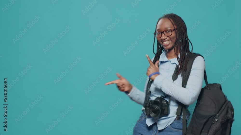 Photographer pointing at left and right side in studio, indicating ...