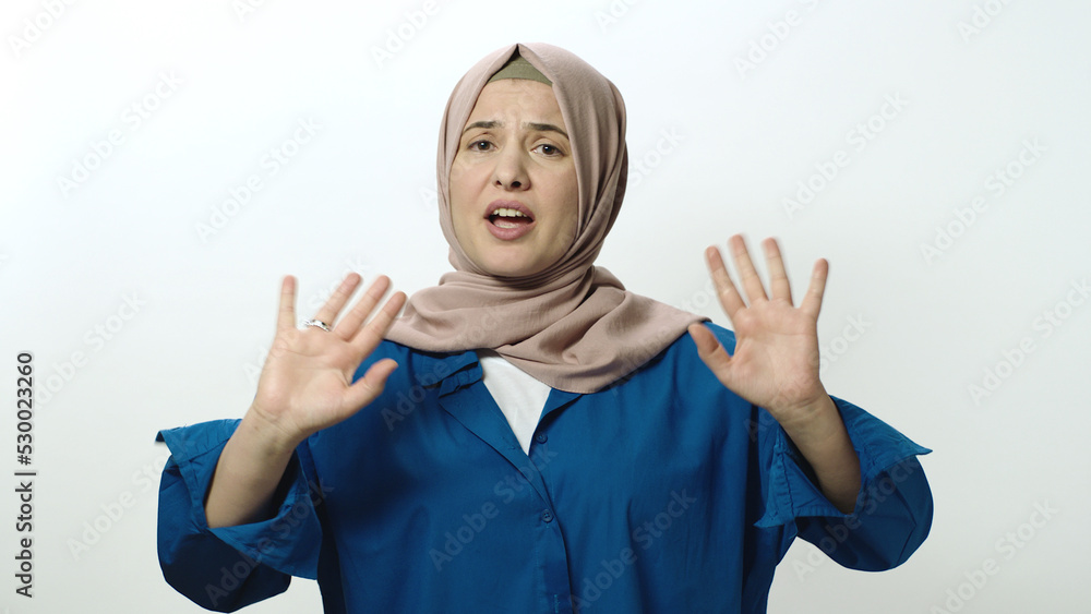 The headscarved woman is very angry at what happened. She shouts ...