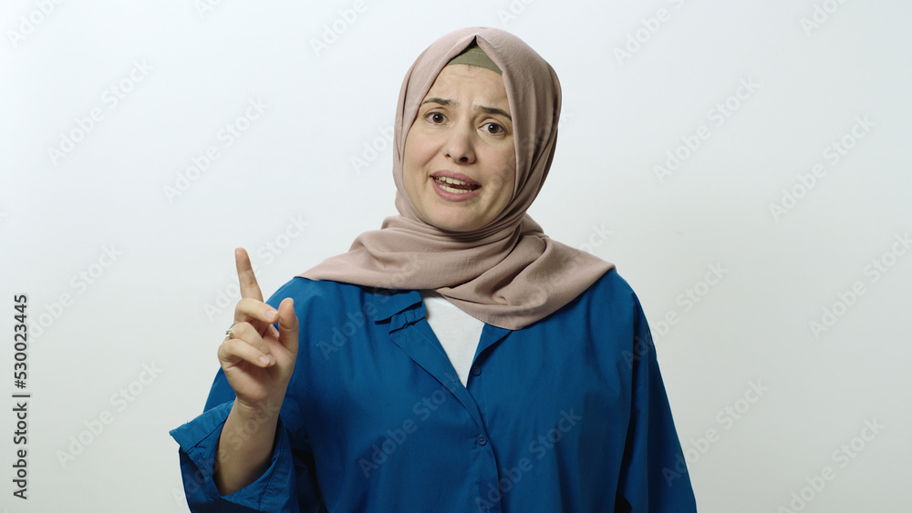 The headscarved woman is very angry at what happened. She shouts ...