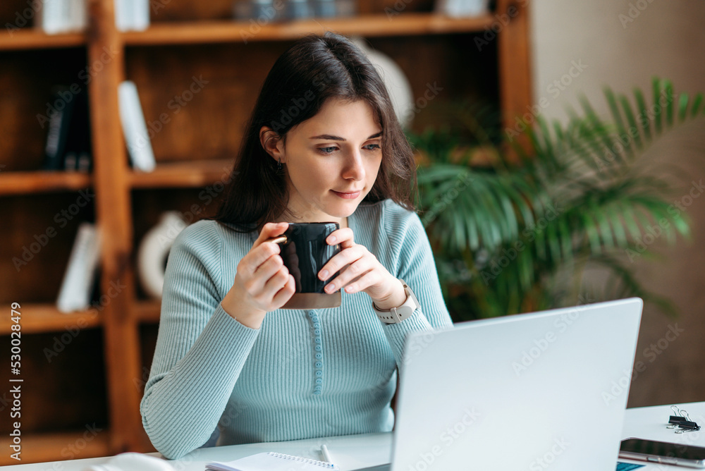 Cute woman learning with laptop at home. Student girl working on ...