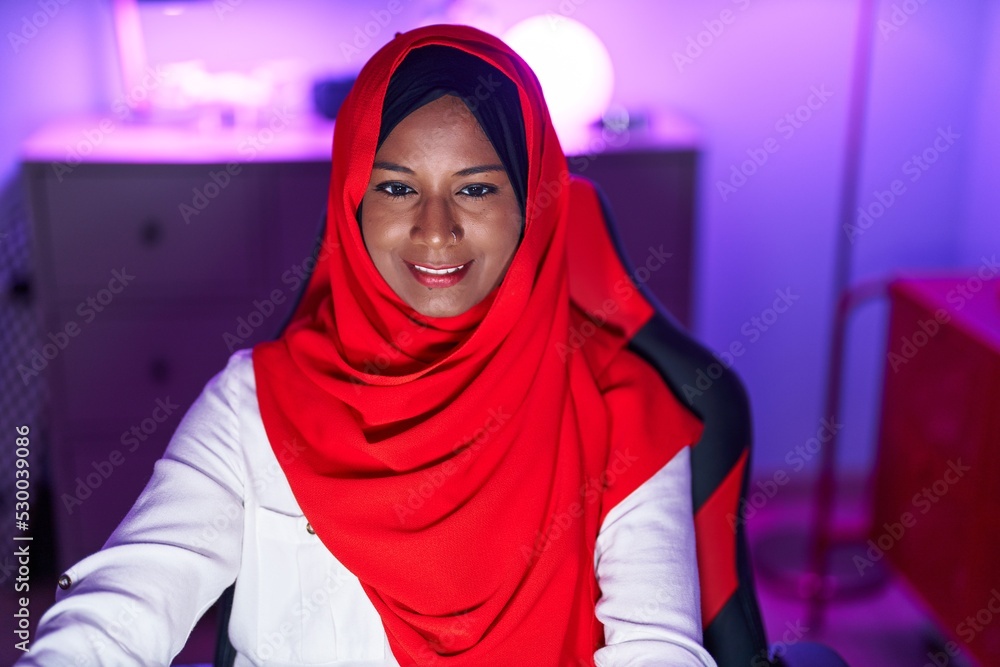 Young beautiful woman streamer playing video game using computer at ...