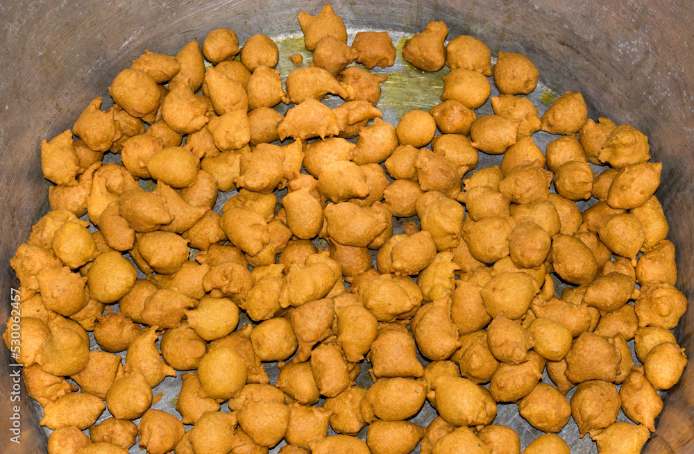 Fried Pakodi or pakoda in bulk for making Indian Kadhi. It is made with ...